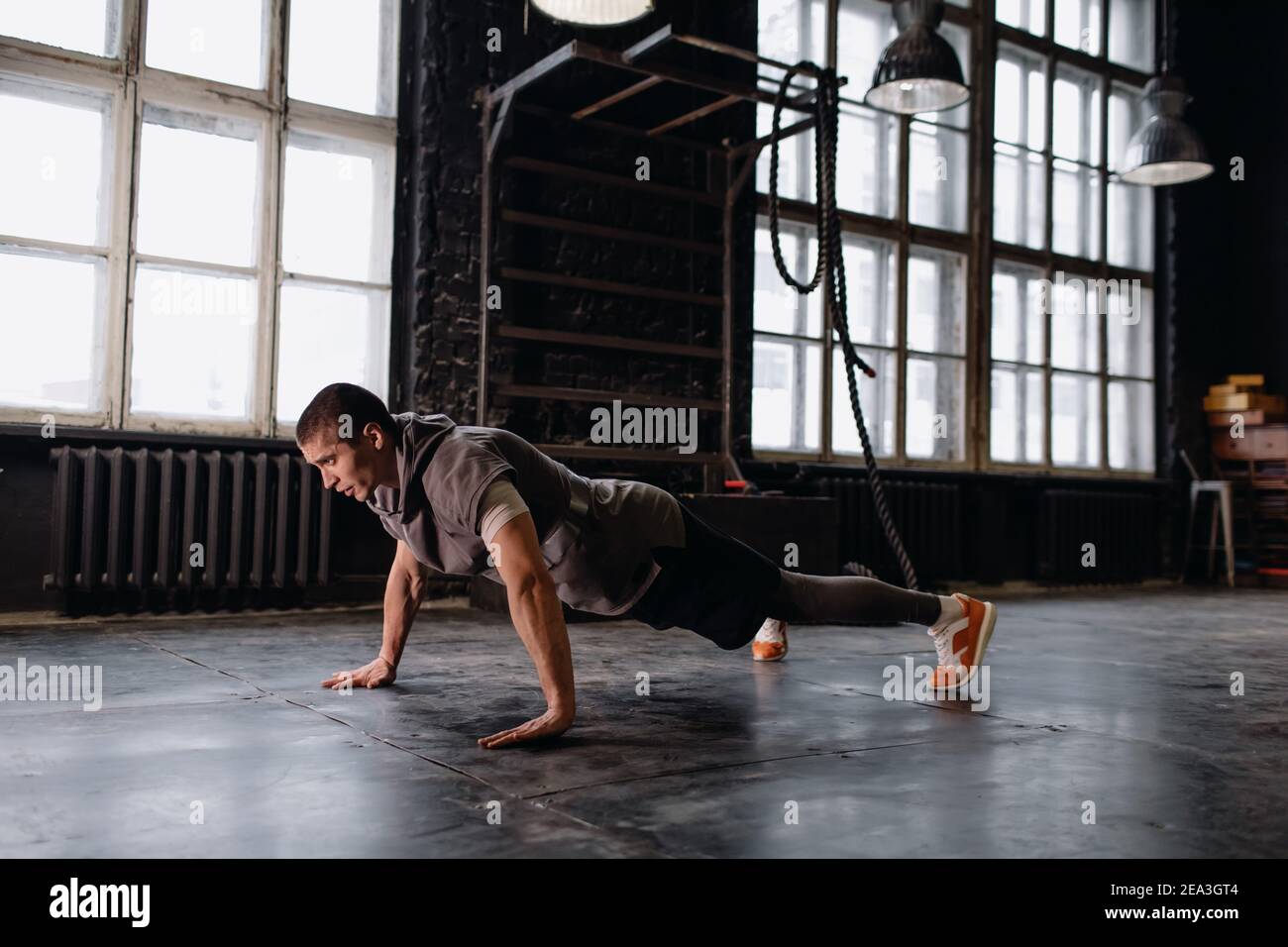 Cool man fighter in boxing bandages trains in the gym. Mixed martial ...