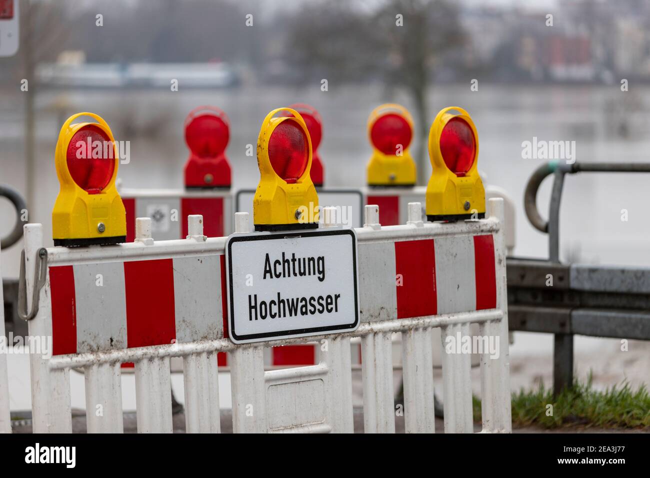 barrier blocking a way to the edge of rhine river, sign with german ...
