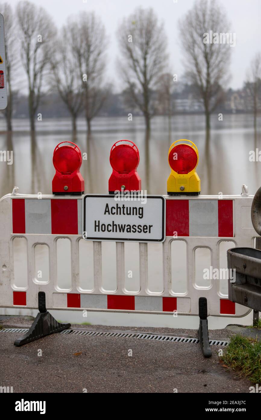 barrier blocking a way to the edge of rhine river, sign with german ...