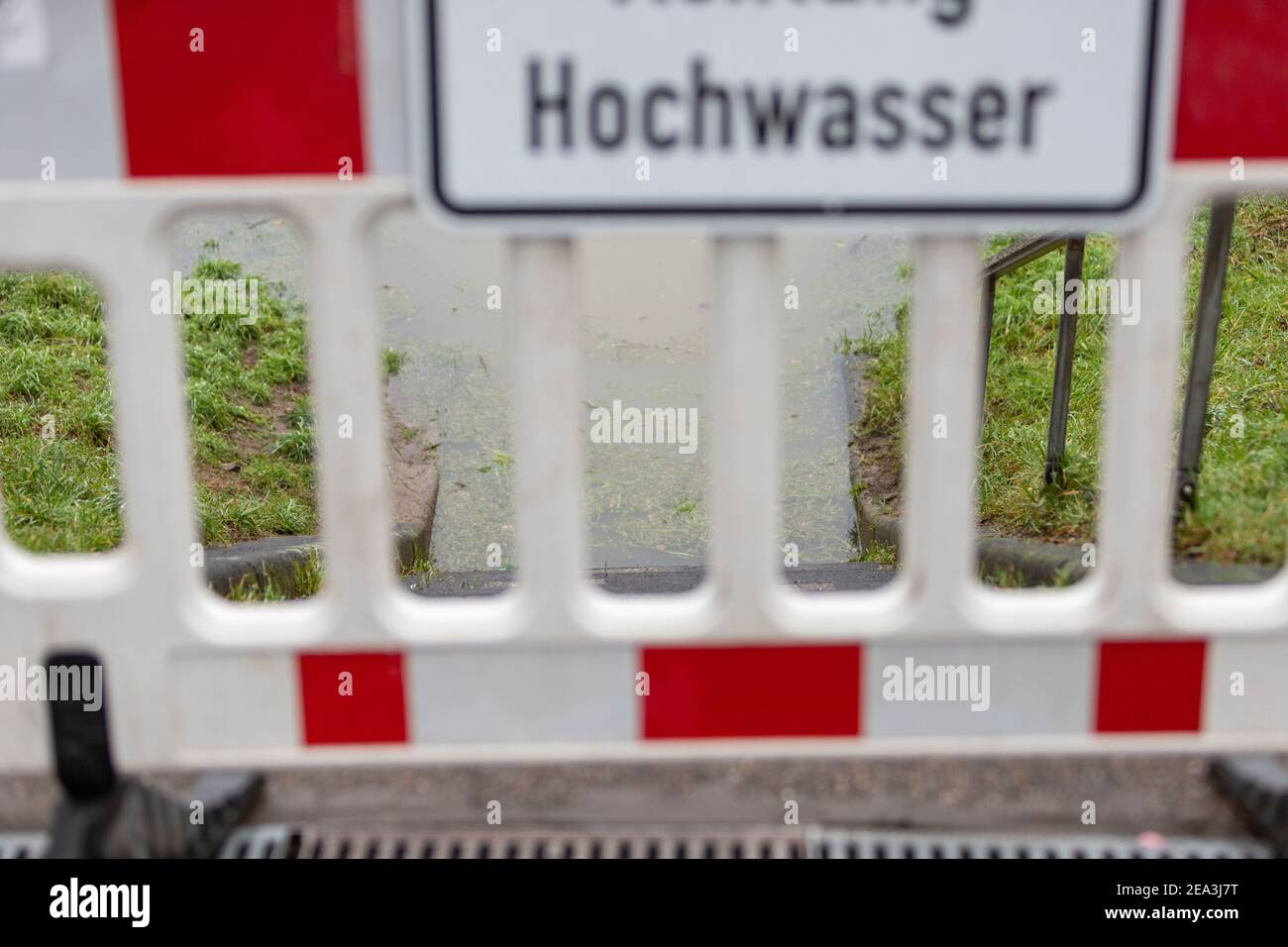barrier blocking a way to the edge of rhine river, sign with german ...