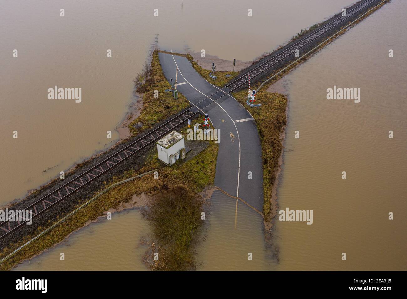 Flooded road passing through the railway. A road under water Stock ...