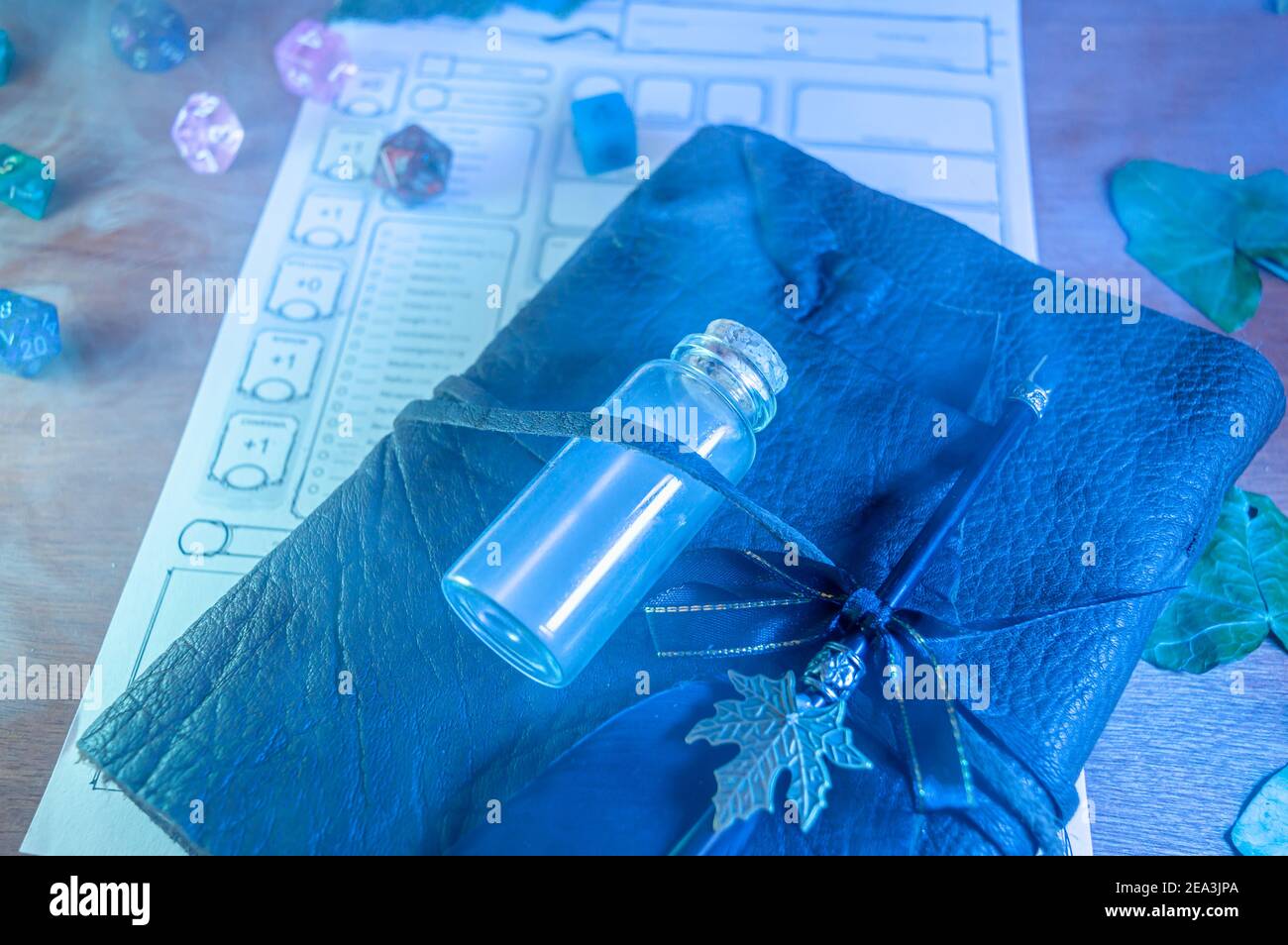 Image of a potion of mist form in a glass bottle and a black quill on a ...