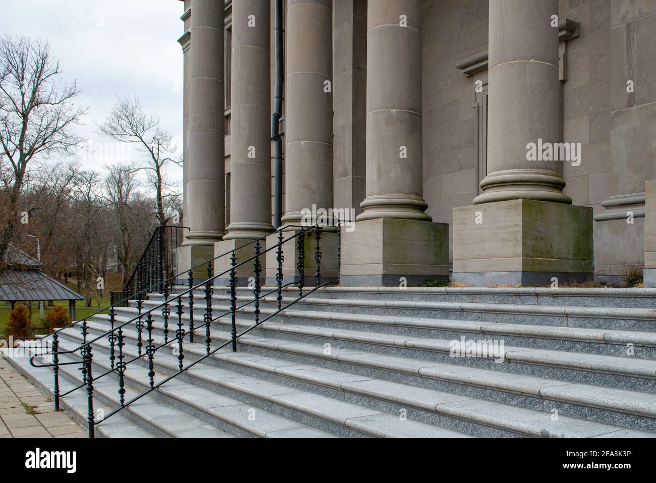 Six large round concrete columns at the top of marble steps with black ...