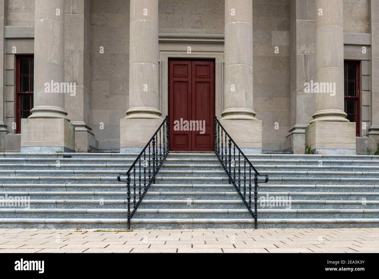 Six large round concrete columns at the top of marble steps with black ...