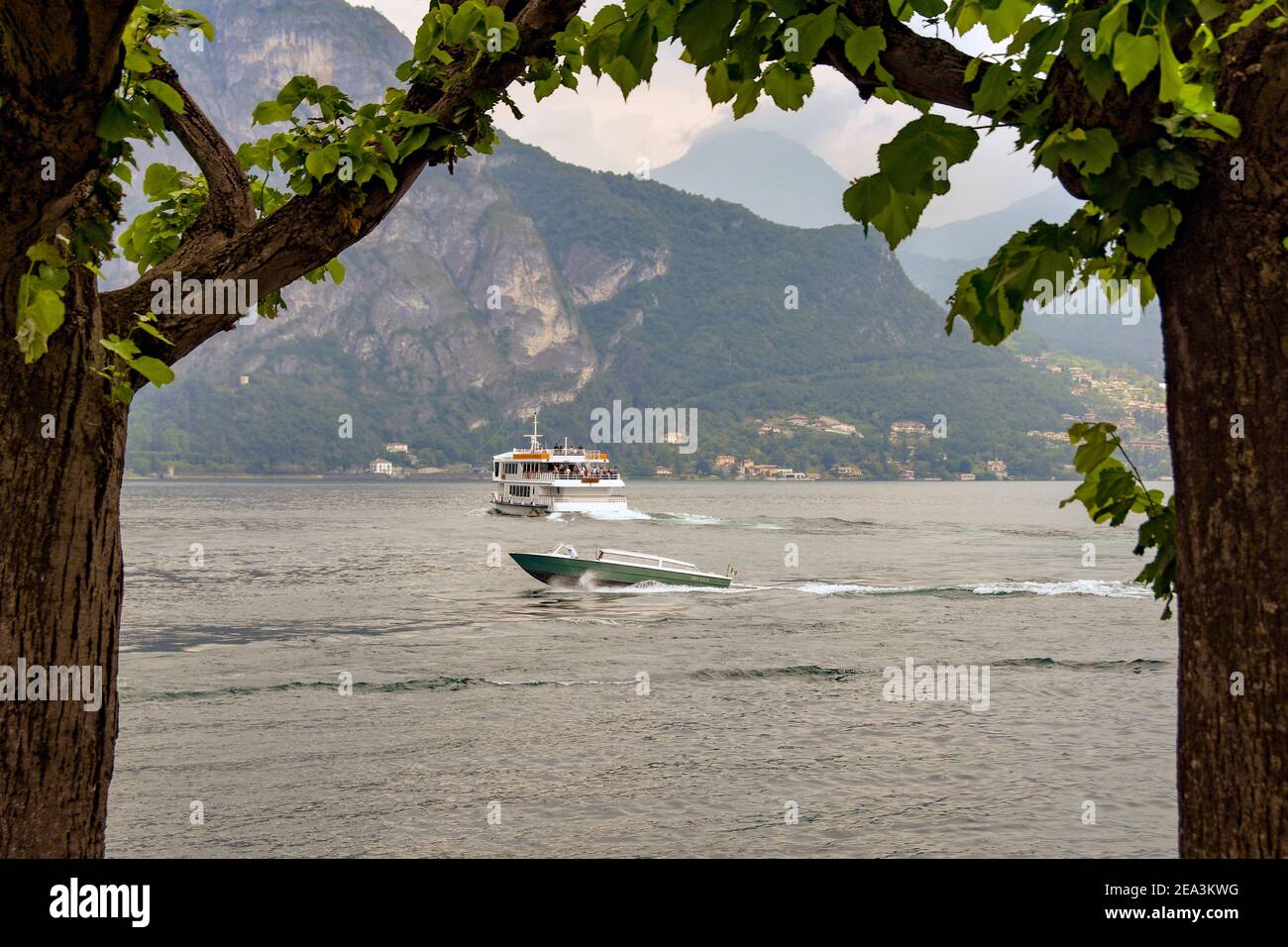 LAKE COMO, ITALY - JUNE 2019: Boats on Lake Como with the view framed ...