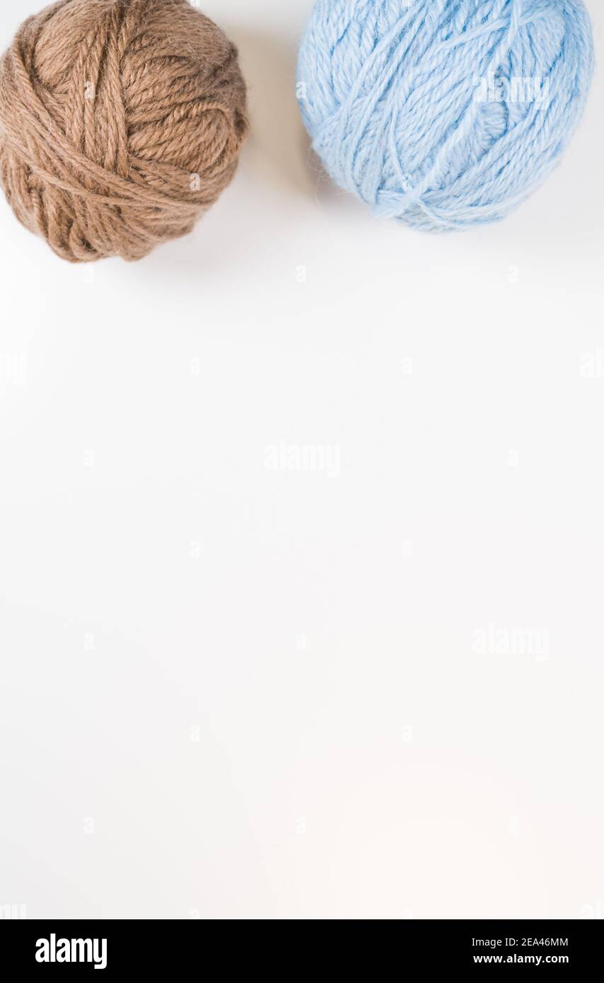 A vertical top view of two wool balls isolated on a white background ...