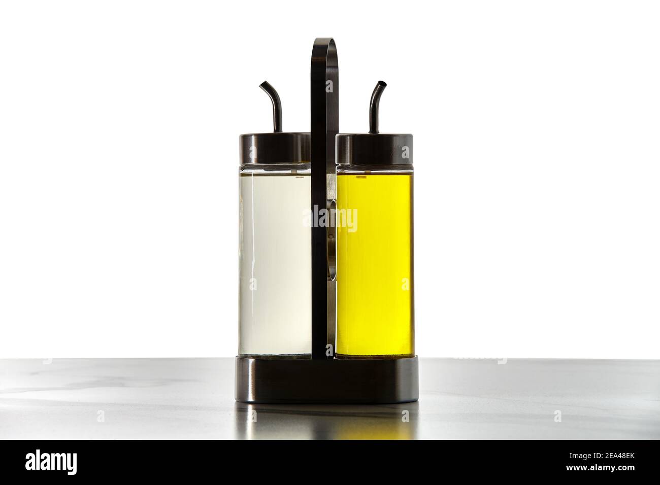 Flasks for storing cooking oil or vinegar are placed in metal holder ...