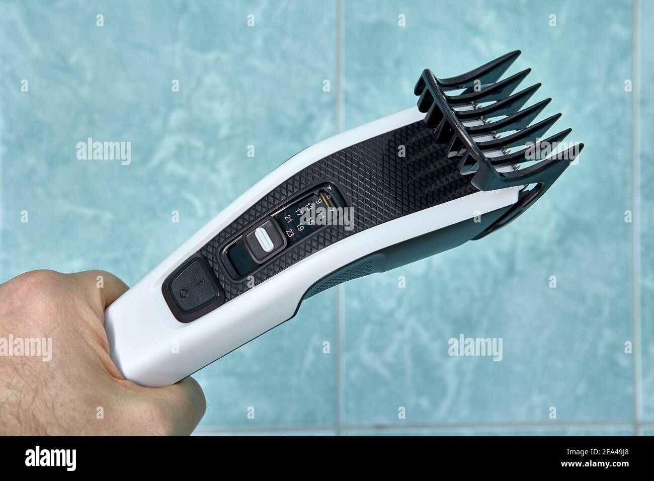 Cordless hair clipper with an attachment in human hand Stock Photo - Alamy