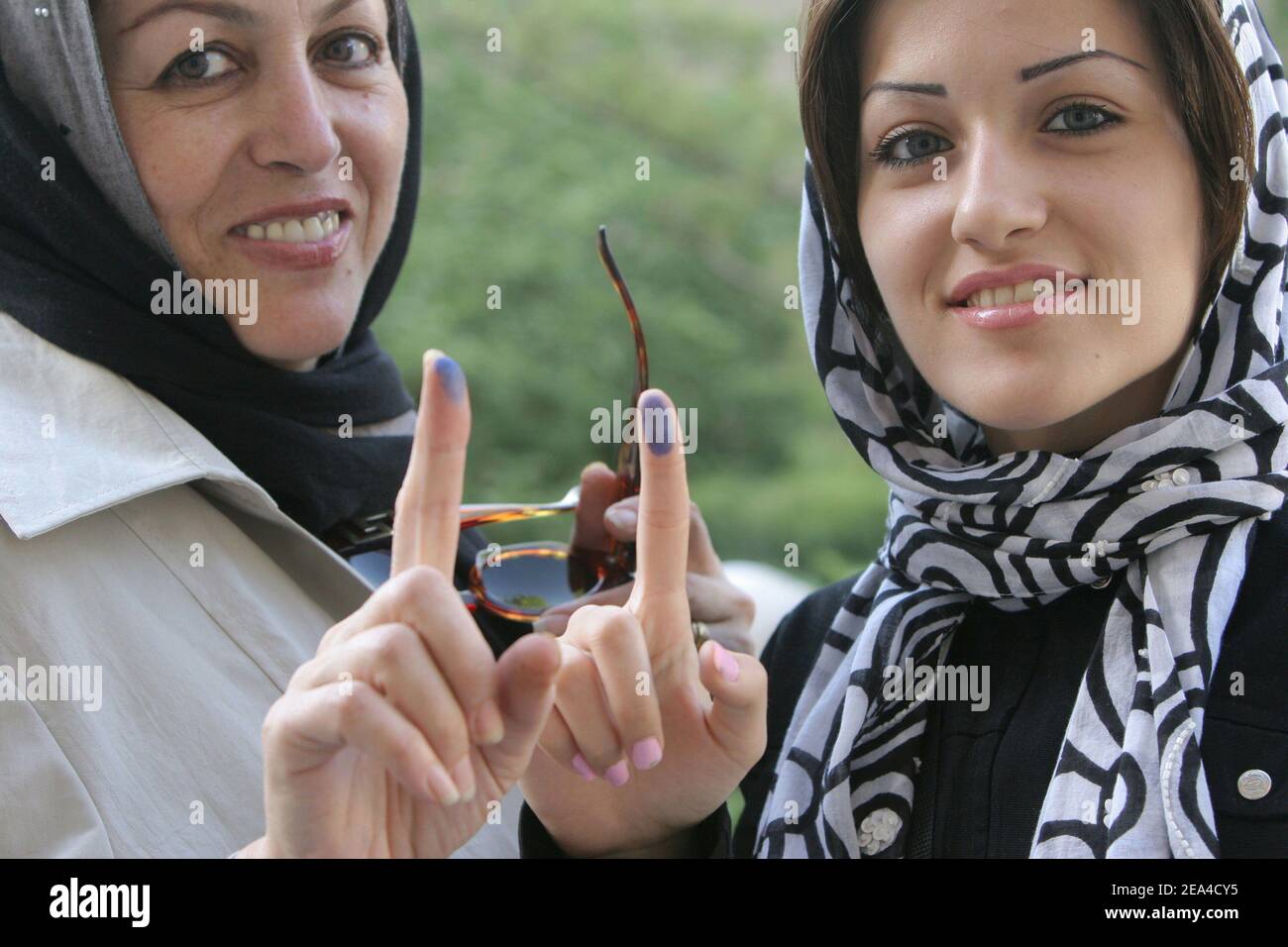 Iranian women show their ink-stained fingers after casting their ...