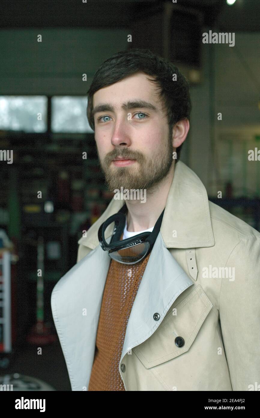 Young handsome man with racing goggles around his neck standing in ...