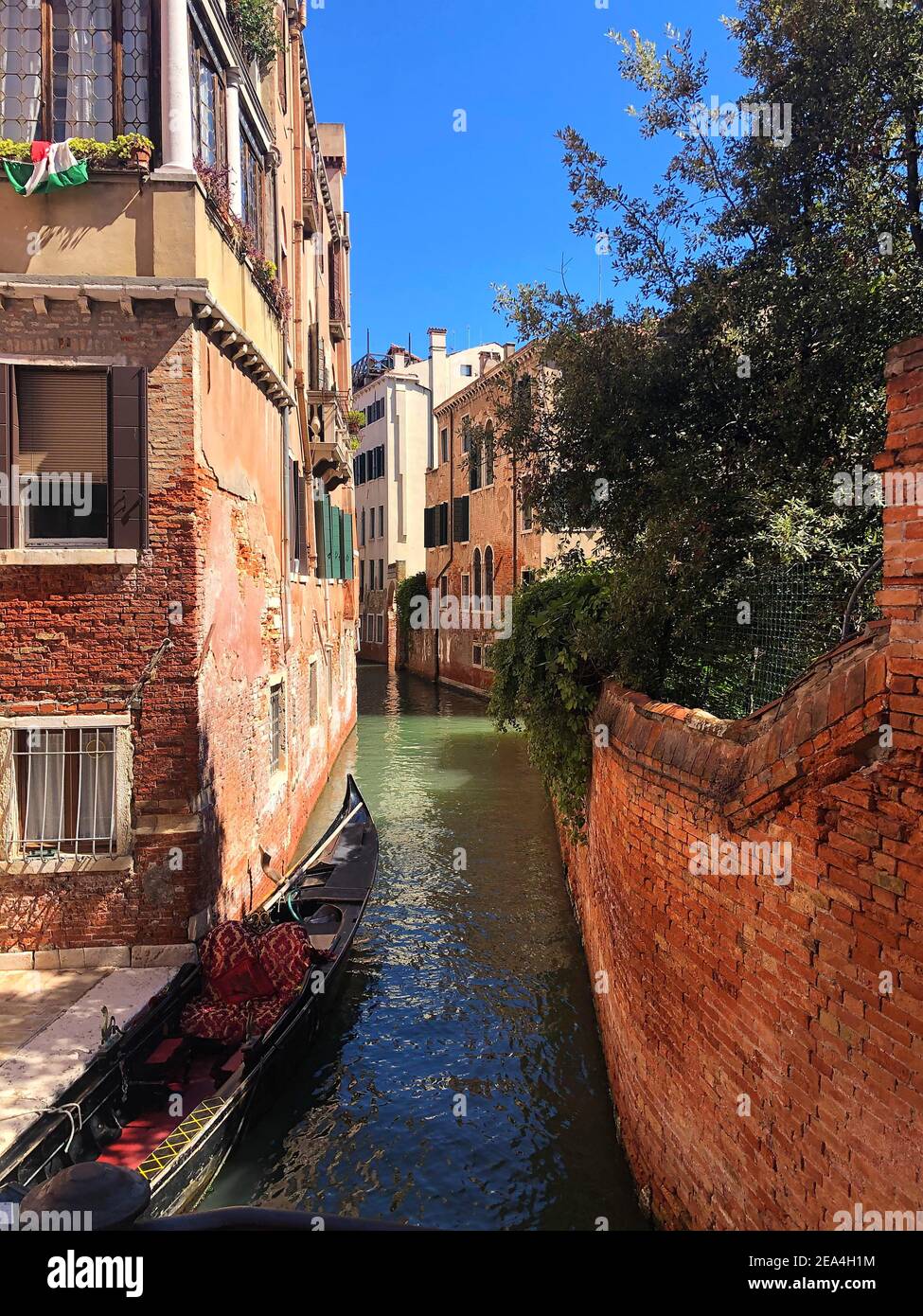 A vertical shot of a floating boat along with the buildings in Venice ...