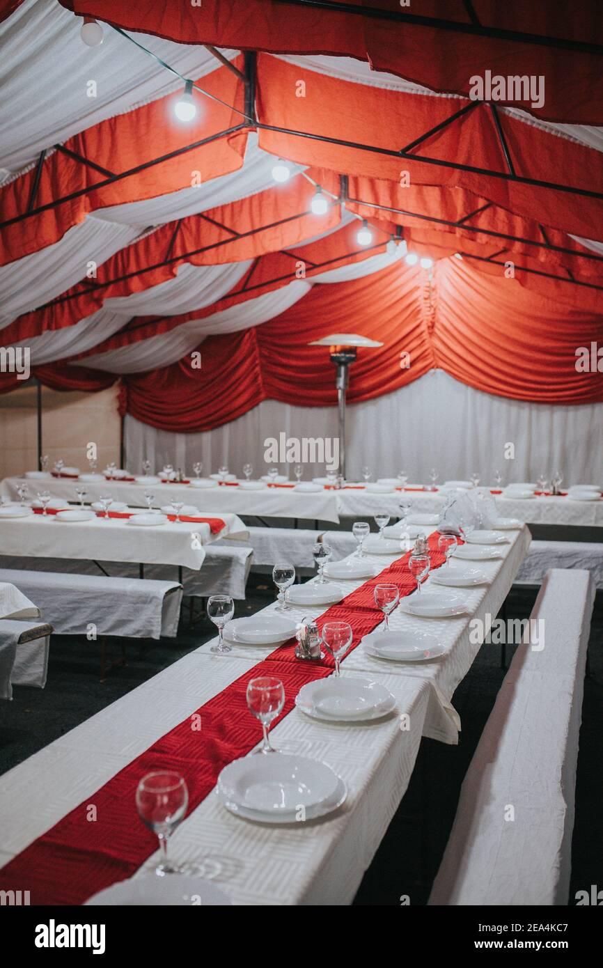 A vertical shot of wedding hall with red and white decorations and ...