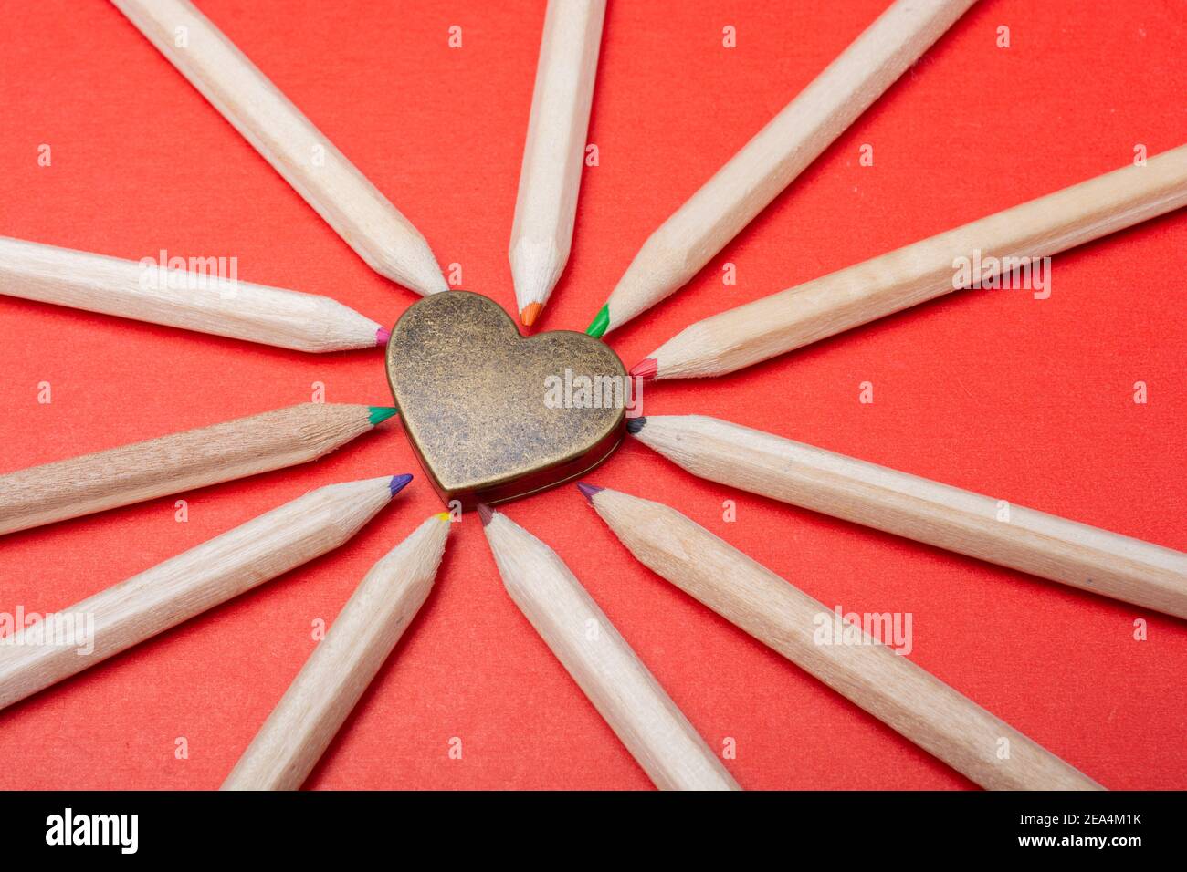 Heart laid out with sharpened multi-colored pencils Stock Photo - Alamy