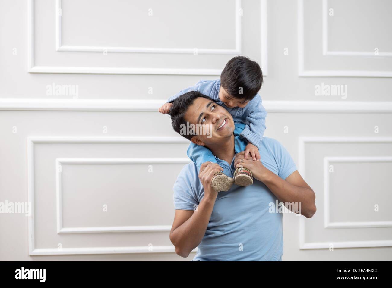 Mexican father and son happily playing at home Stock Photo - Alamy