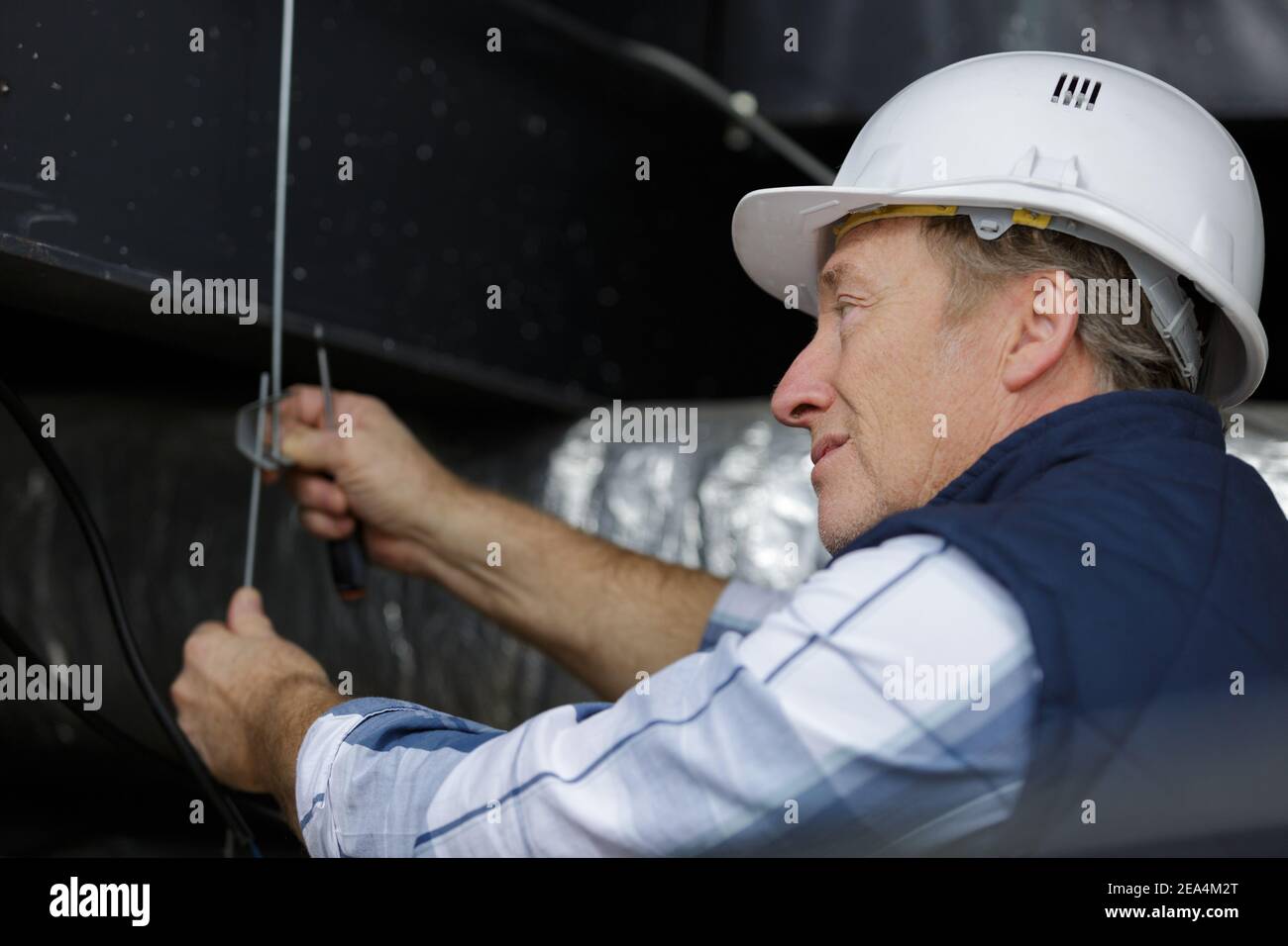 electrician working with indoors cables Stock Photo - Alamy