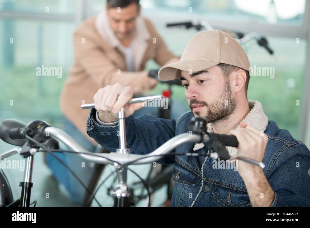 man bike mechanic with a beard assembles a mountain bike Stock Photo ...