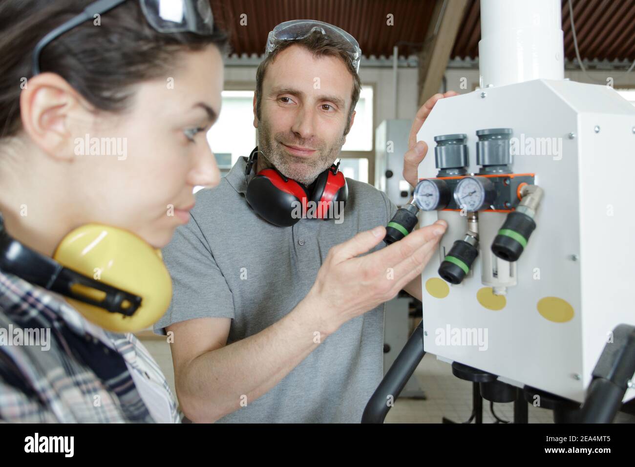 engineer showing equipment to a female apprentice Stock Photo - Alamy