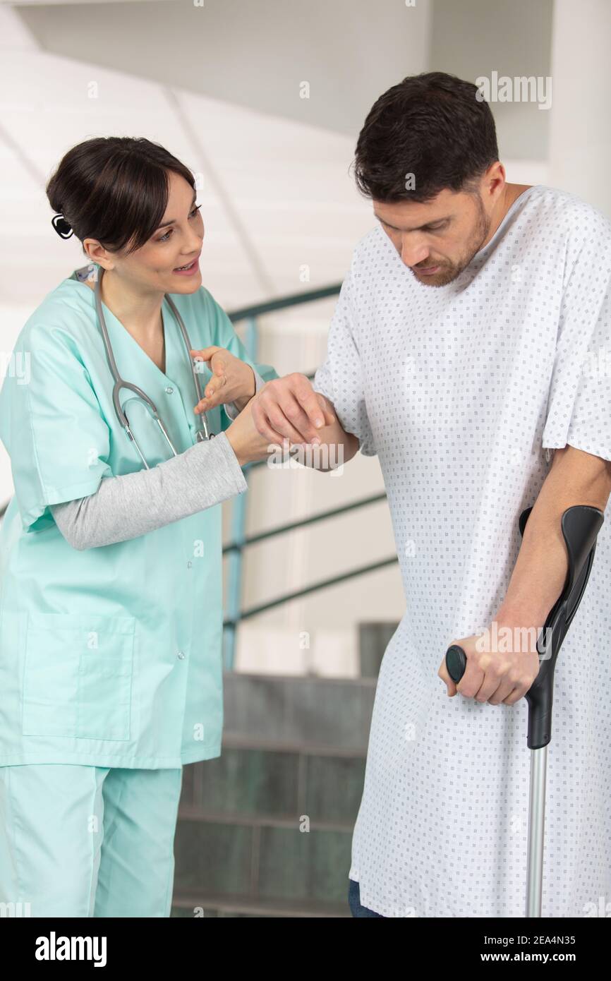 female nurse assisting a patient in hospital stairs Stock Photo - Alamy