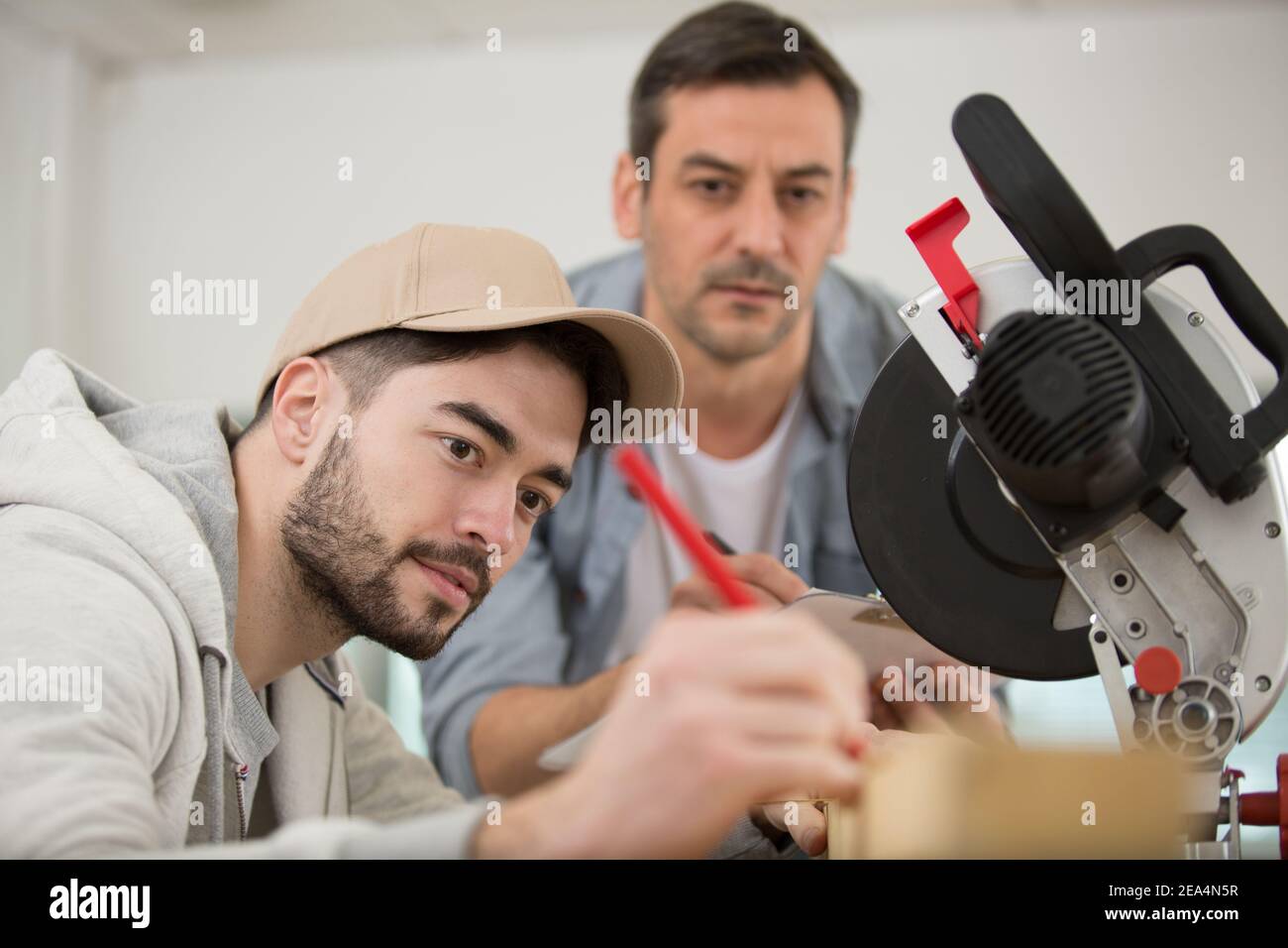 supervisor assessing apprentice to use circular saw Stock Photo - Alamy