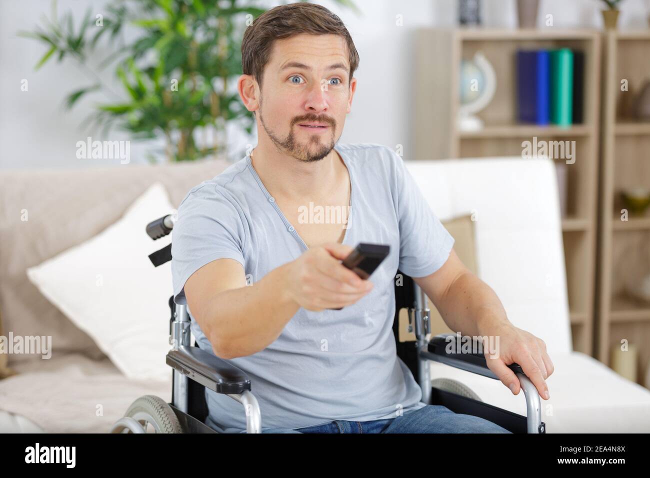 disable man with the remote control Stock Photo - Alamy