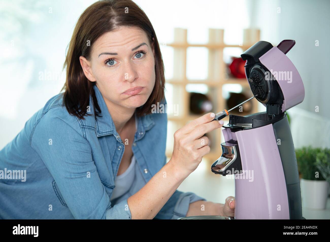 Woman fixing coffee machine hi-res stock photography and images - Alamy