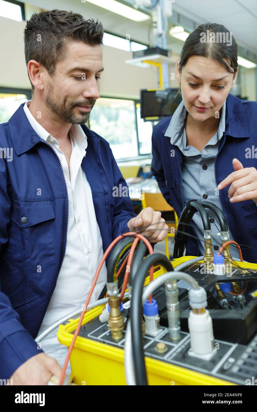 portrait of technicians working with cables Stock Photo - Alamy