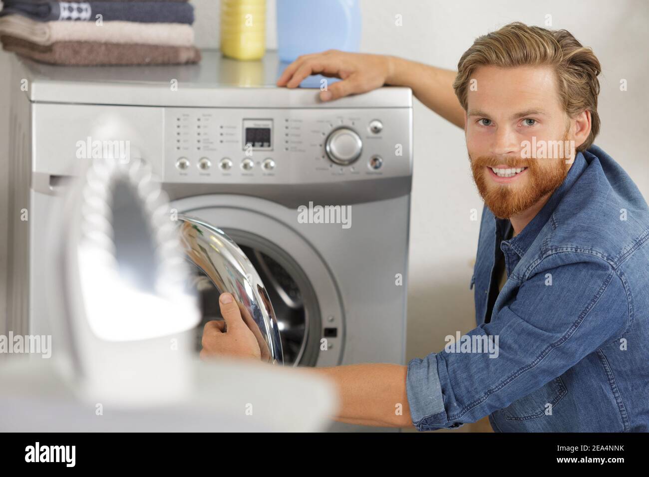 Man reaching into dryer hi-res stock photography and images - Alamy