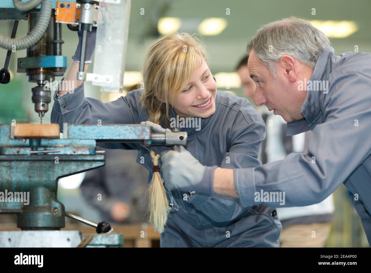 smiling young lady engineer working in factory milling machine Stock ...