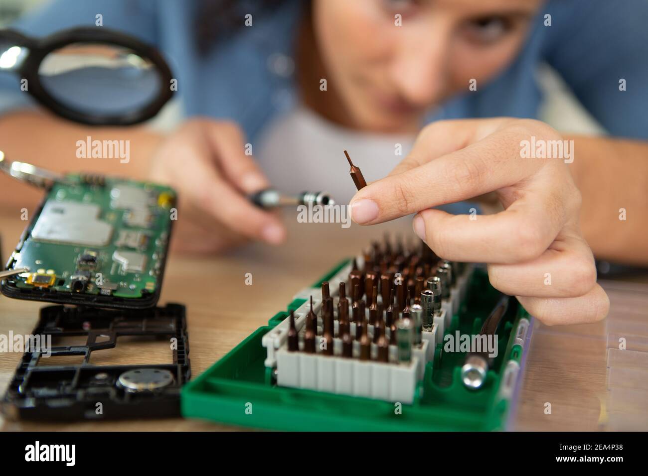 young woman fix pc component in service center Stock Photo - Alamy