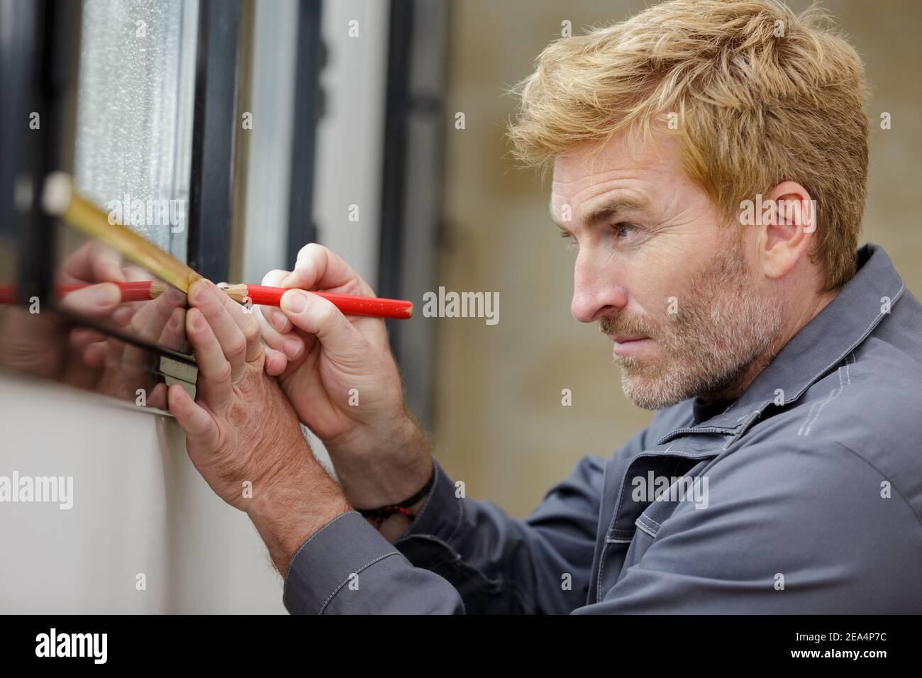 technician measuring a window frame with a measuring tape Stock Photo ...