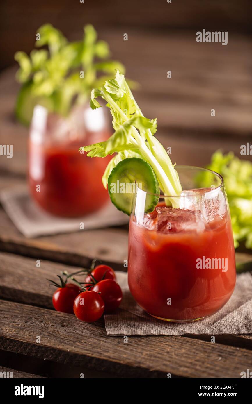 Bloody or virgin mary cocktail served in a cup with celery sticks and ...