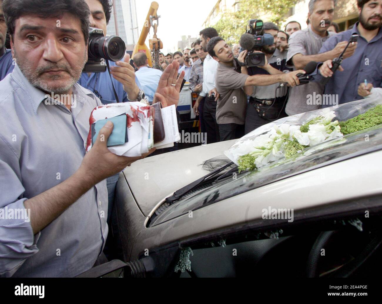 An Iranian official takes the bloody belongings of Iranian magistrate ...
