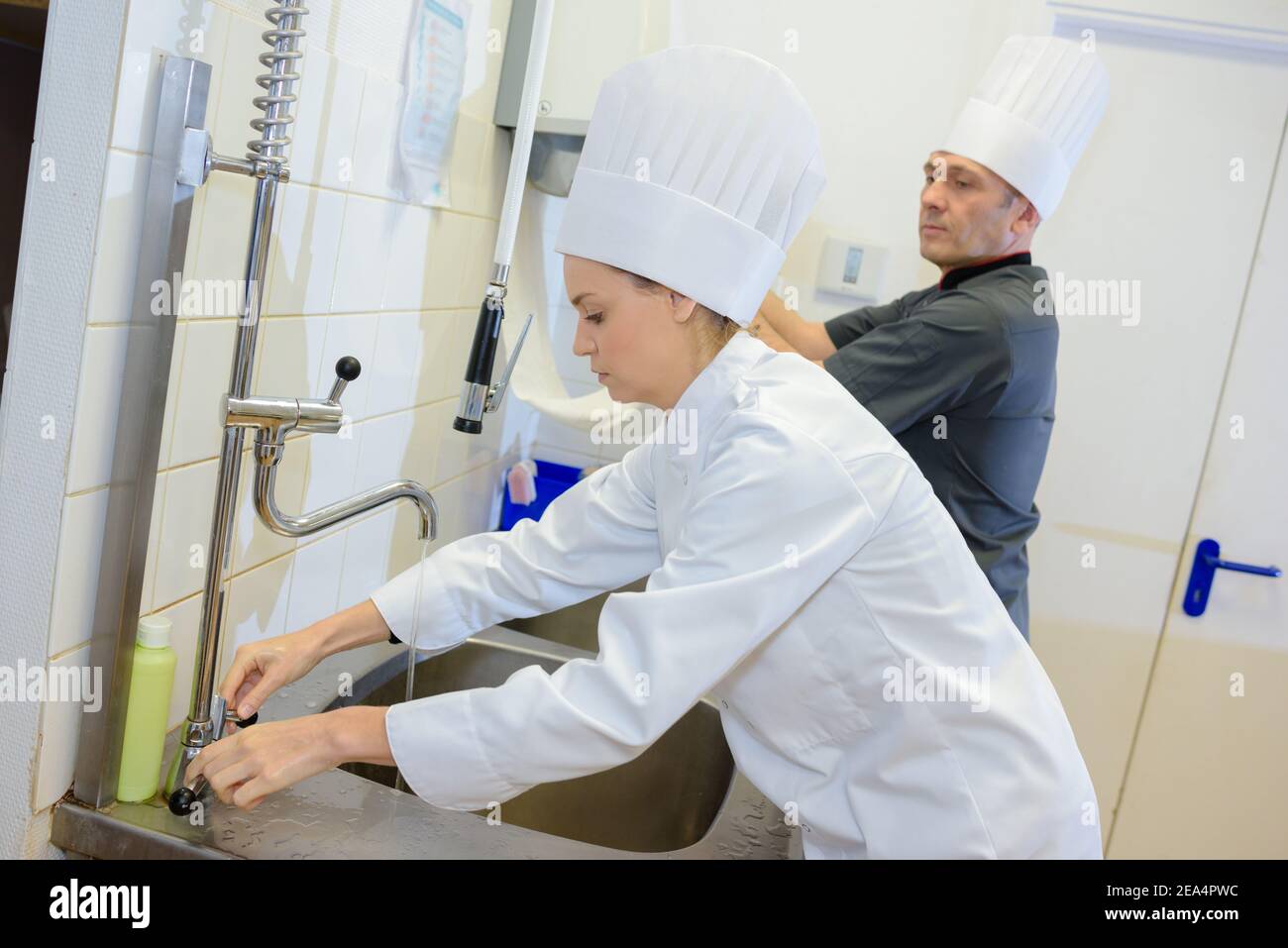 female chef washing hand under running water Stock Photo - Alamy