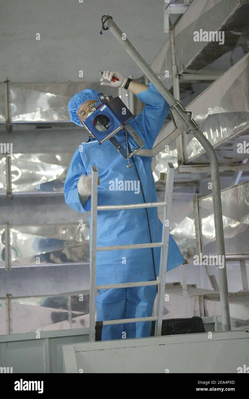 An inspector of the International Atomic Energy Agency IAEA installs a ...