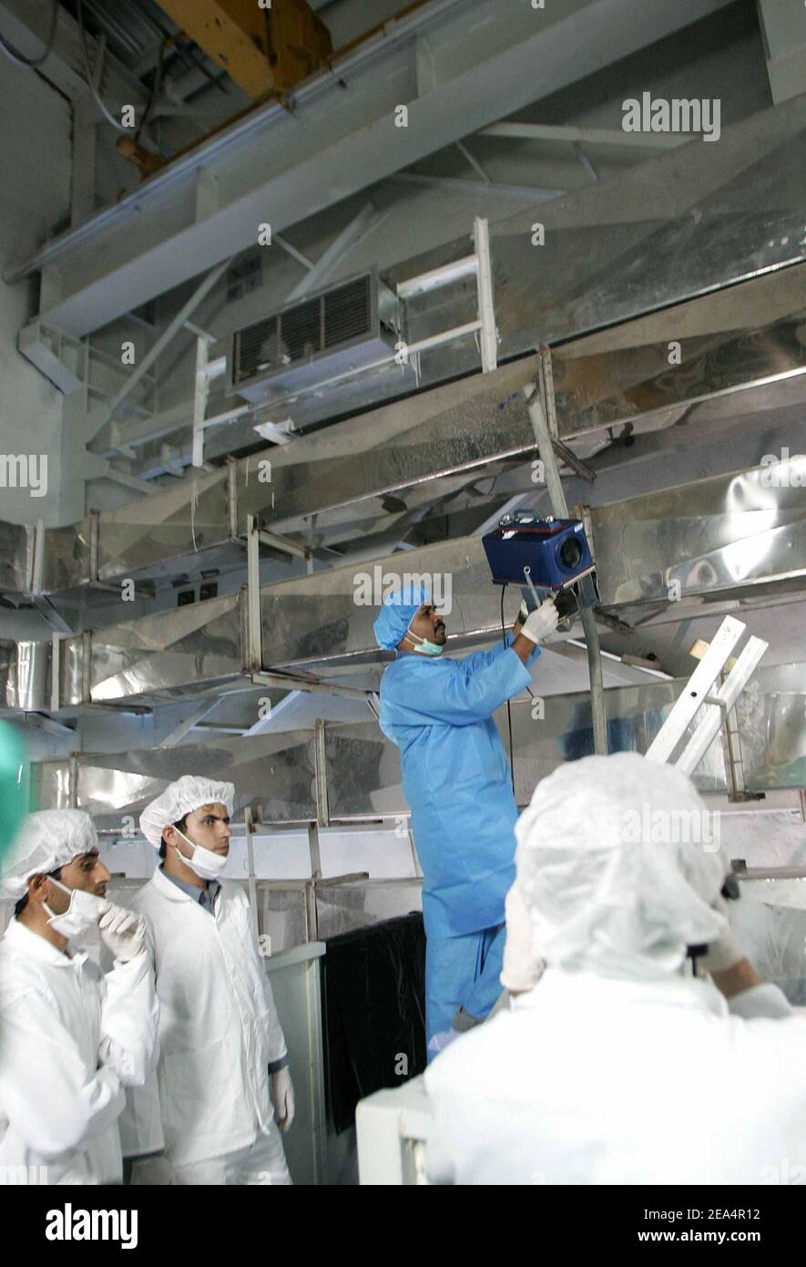 An inspector of the International Atomic Energy Agency IAEA installs a ...