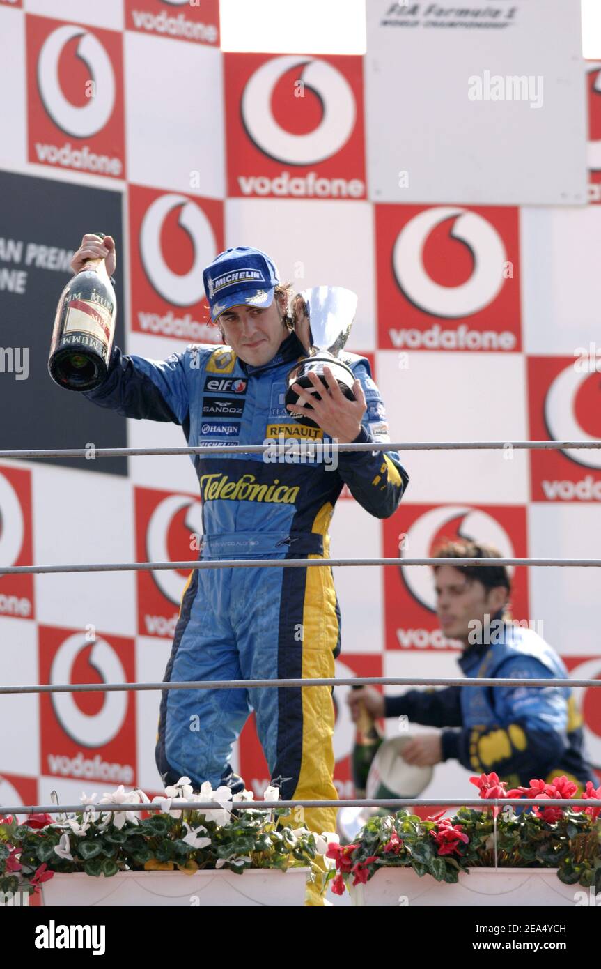 Spanish Fernando Alonso and Italian Giancarlo Fisichella of Renault celebrate their second and ...
