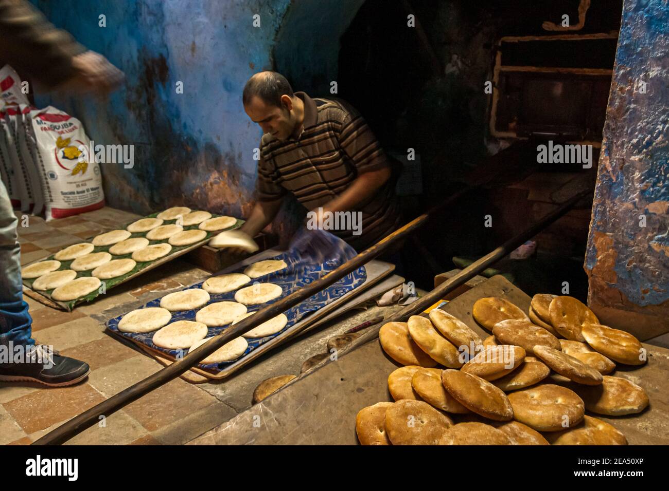 The baker in the medina of Fes bakes the customers' own loaves of bread ...