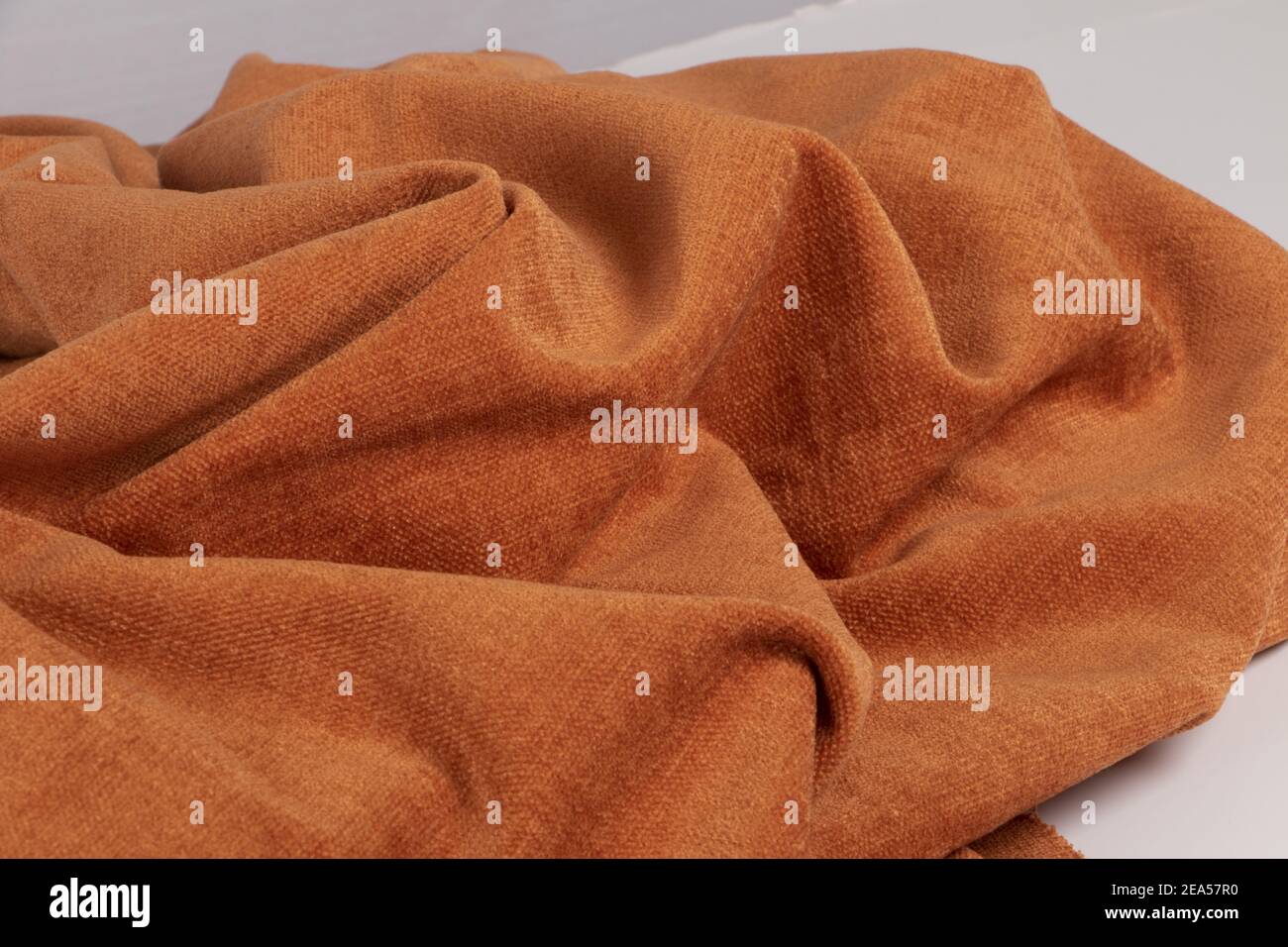 A closeup of a wrinkled natural orange chenille fabric texture Stock ...