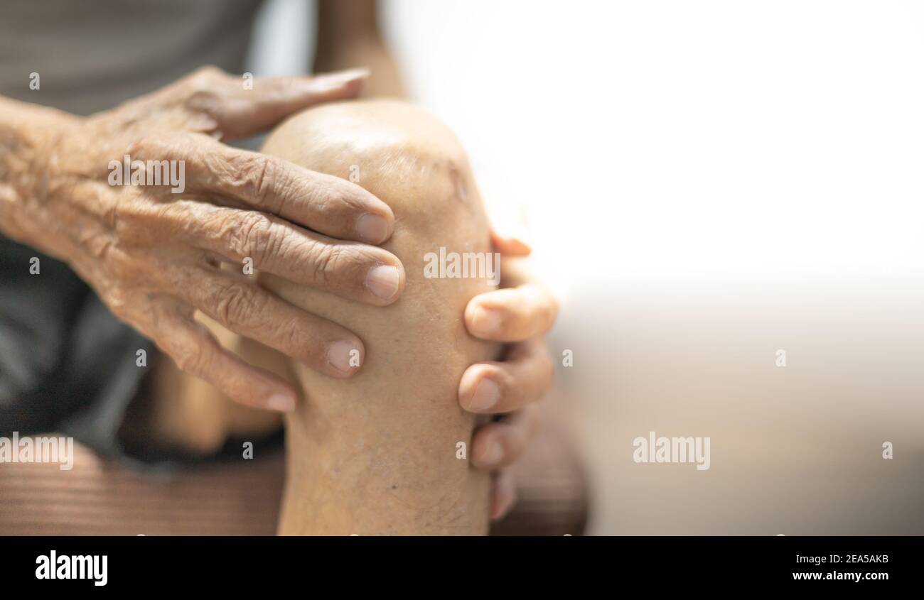 Close up of old man hand holding on the knee with suffering from knee ...