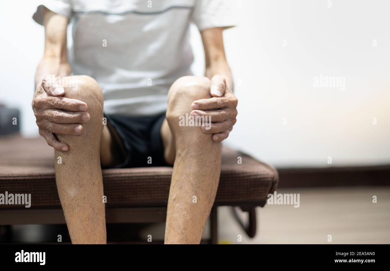 Close up of old man hand holding on the knee with suffering from knee ...