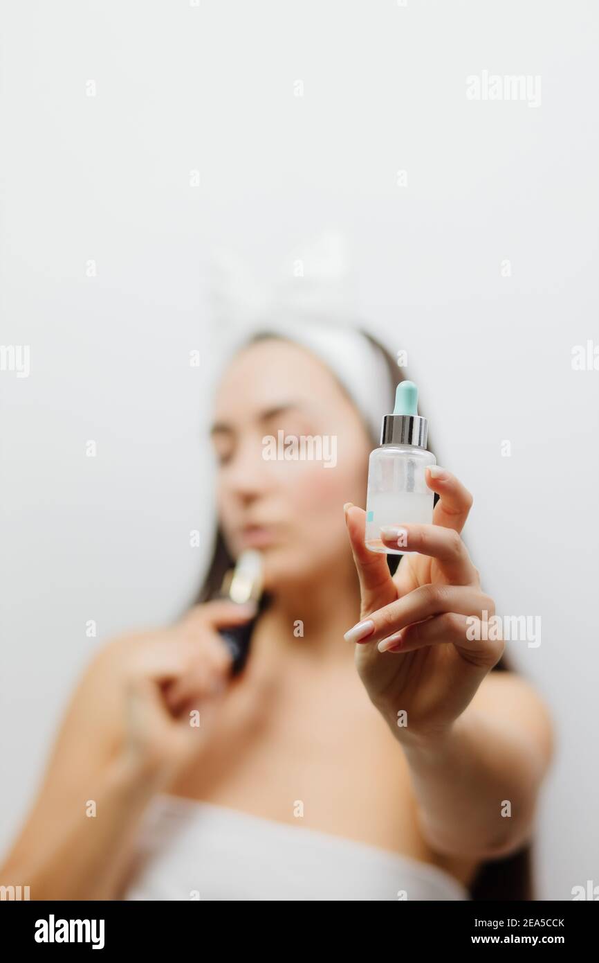 woman using face serum after cleansing and toning Stock Photo - Alamy