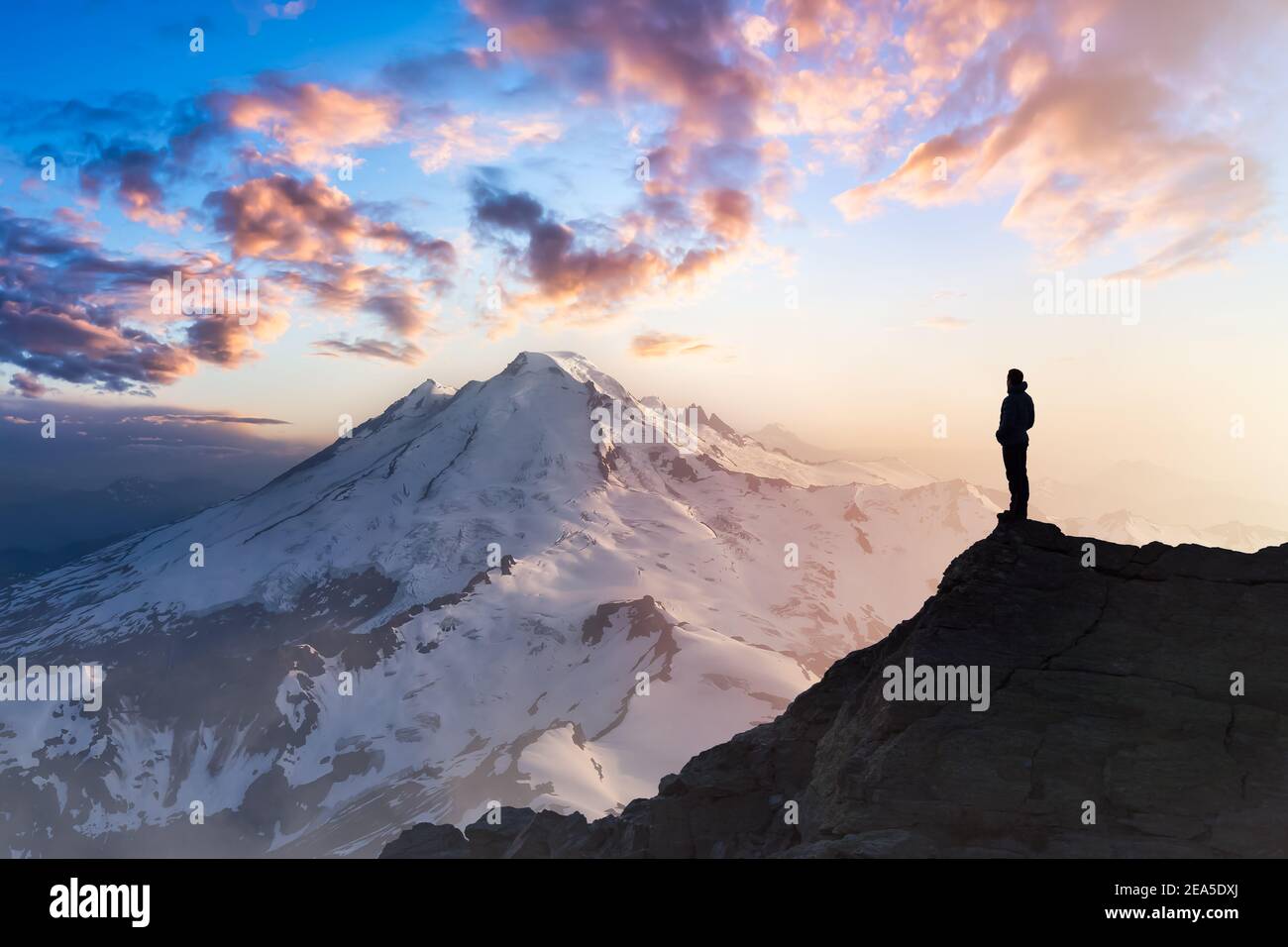 Adventurous Man Hiker on top of a Steep Rocky Cliff Stock Photo - Alamy