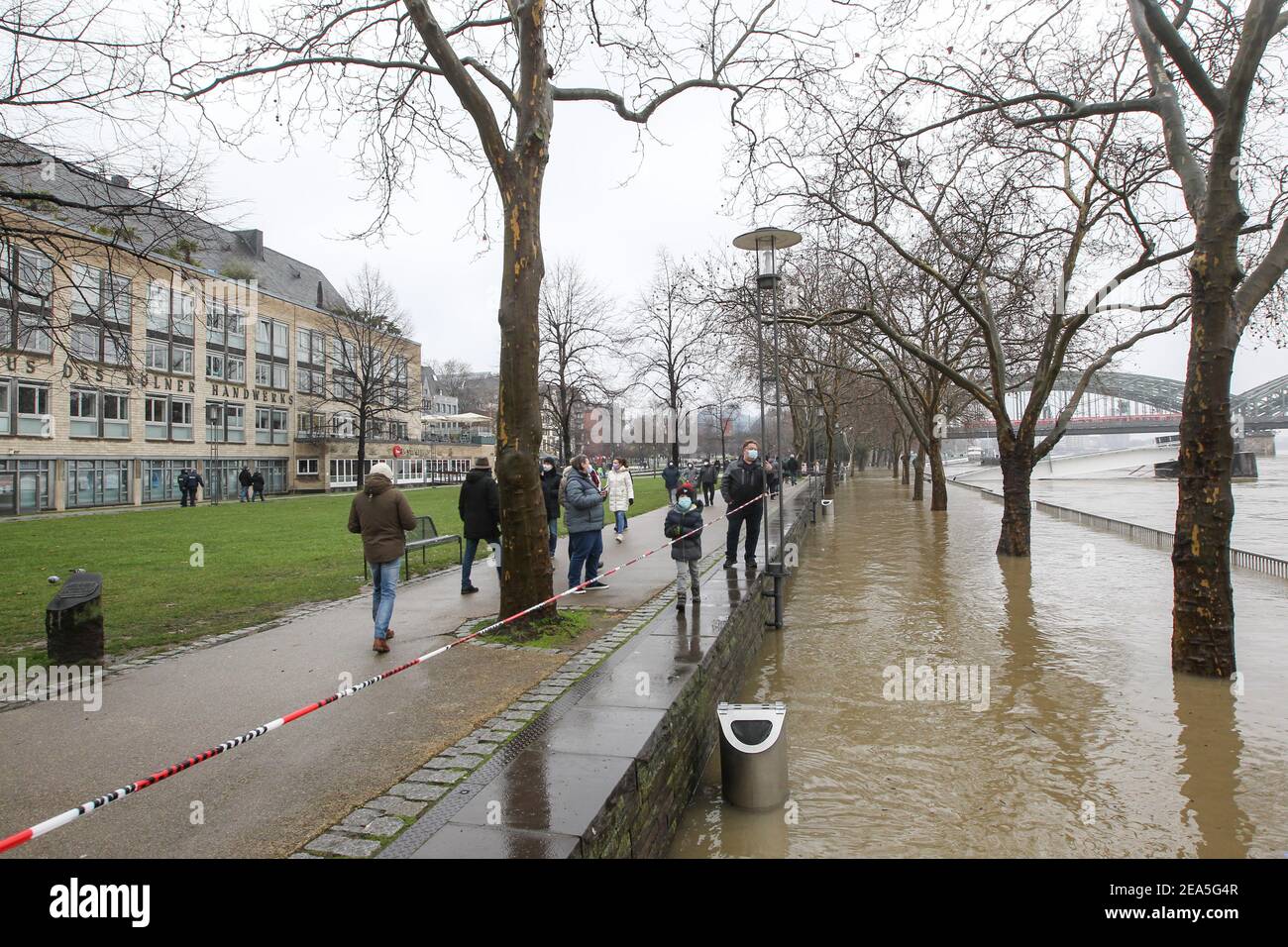 People walk along the flooded banks of the Rhine river. Heavy rainfall ...