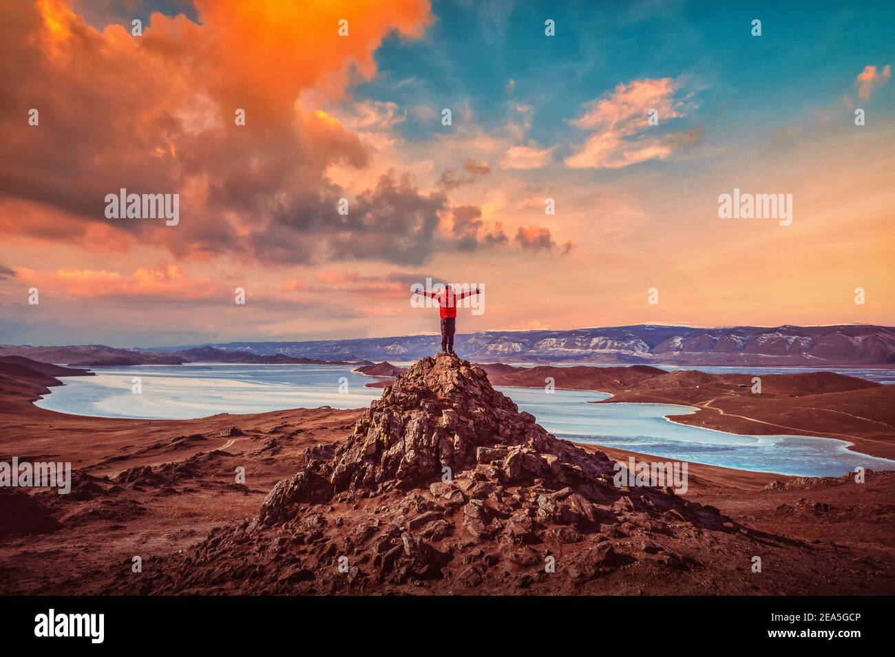 Traveler man wear red clothes and raising arm standing on the peak of ...