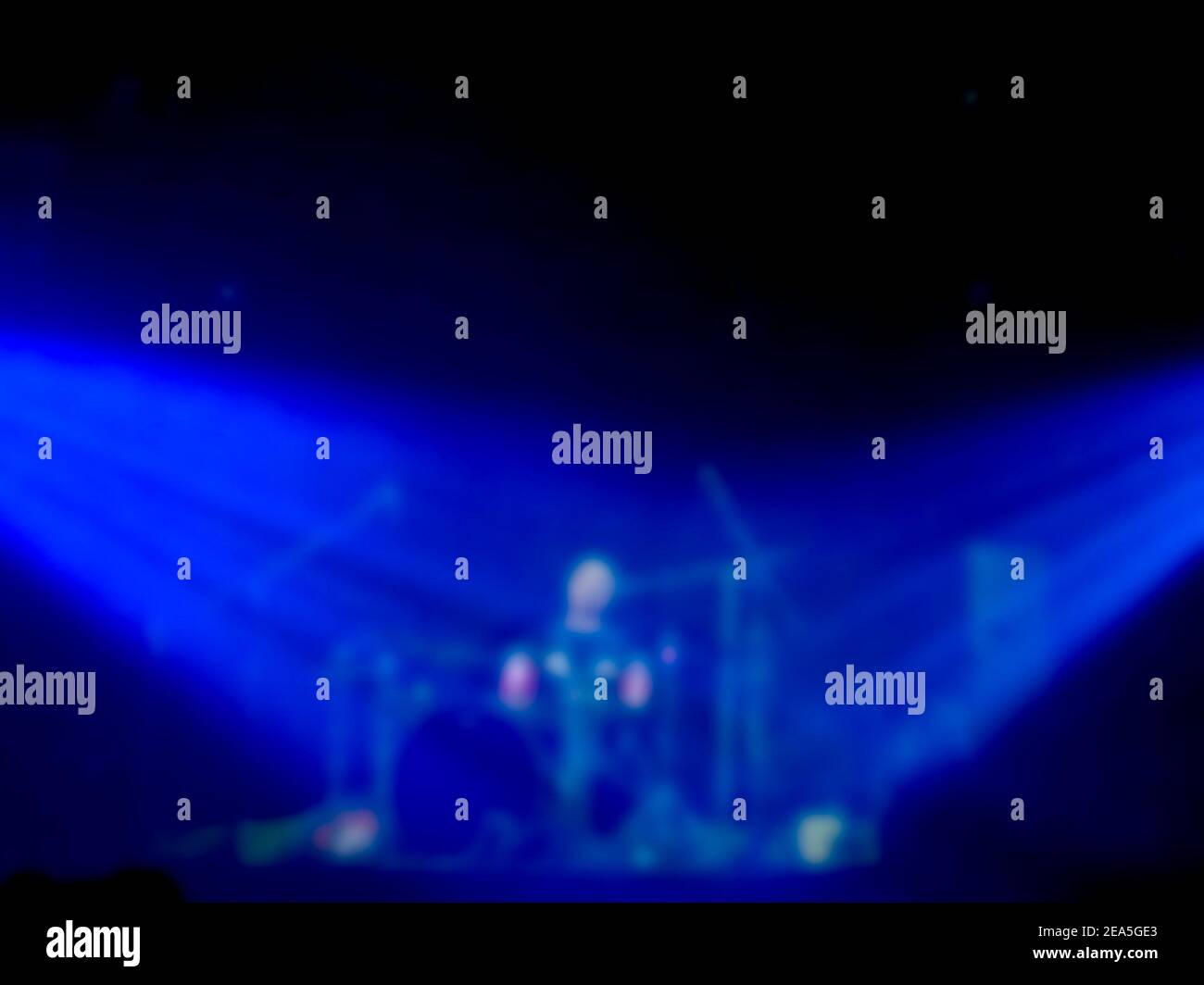 Blurred Asian musician man, drummer playing solo drums on stage with ...