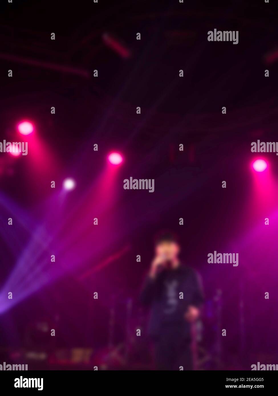 Blurred vocalist man, singer holding microphone and singing a song on ...