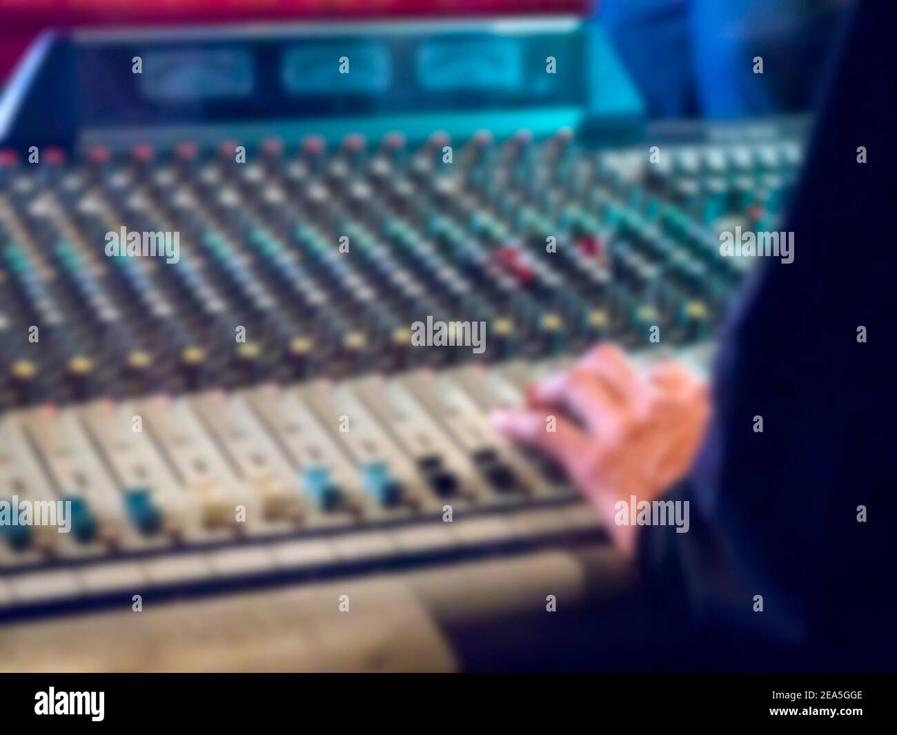 Blurred sound engineer mixer console in concert indoor. Blurry sound ...