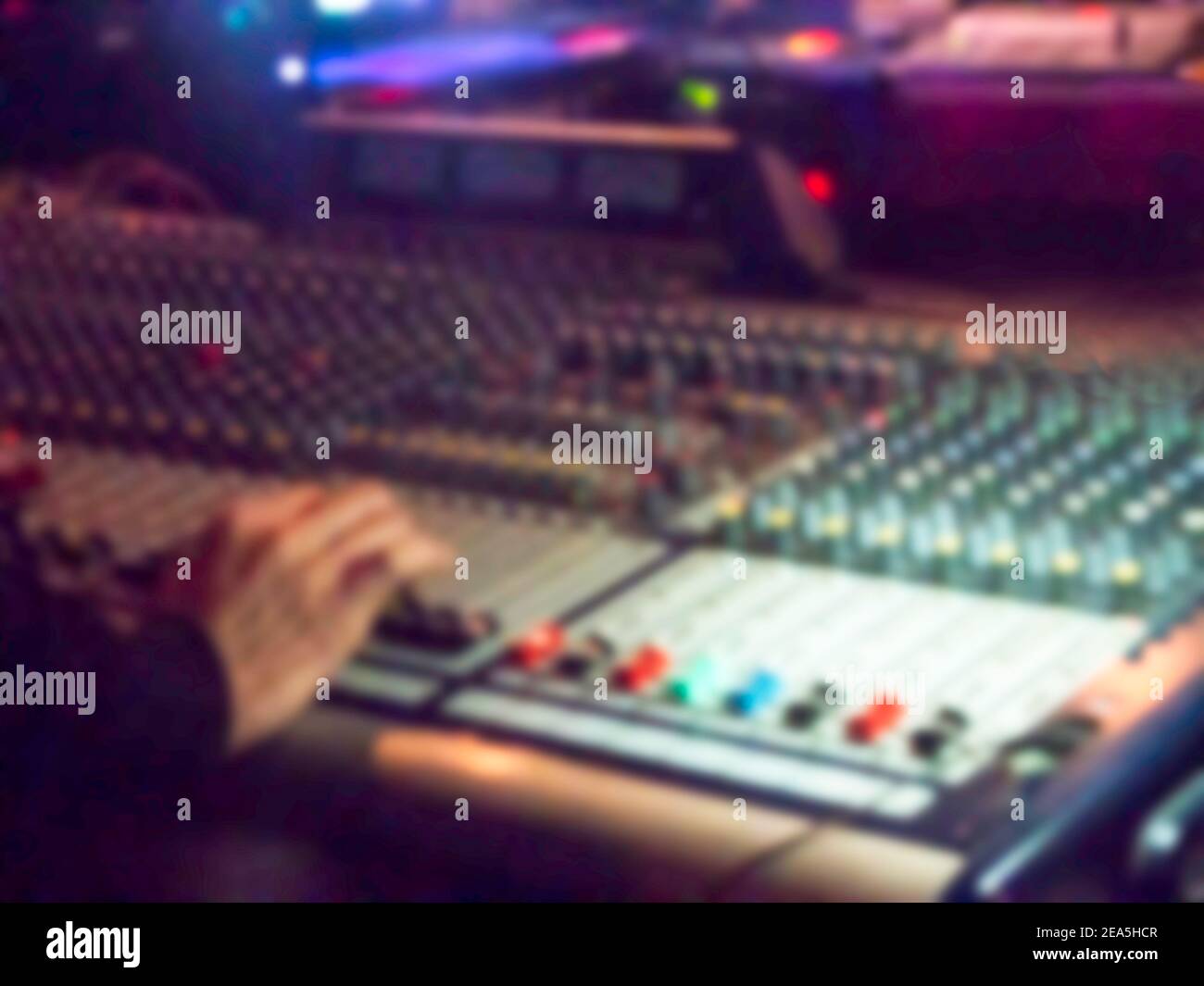 Blurred sound engineer mixer console in concert indoor. Blurry sound ...