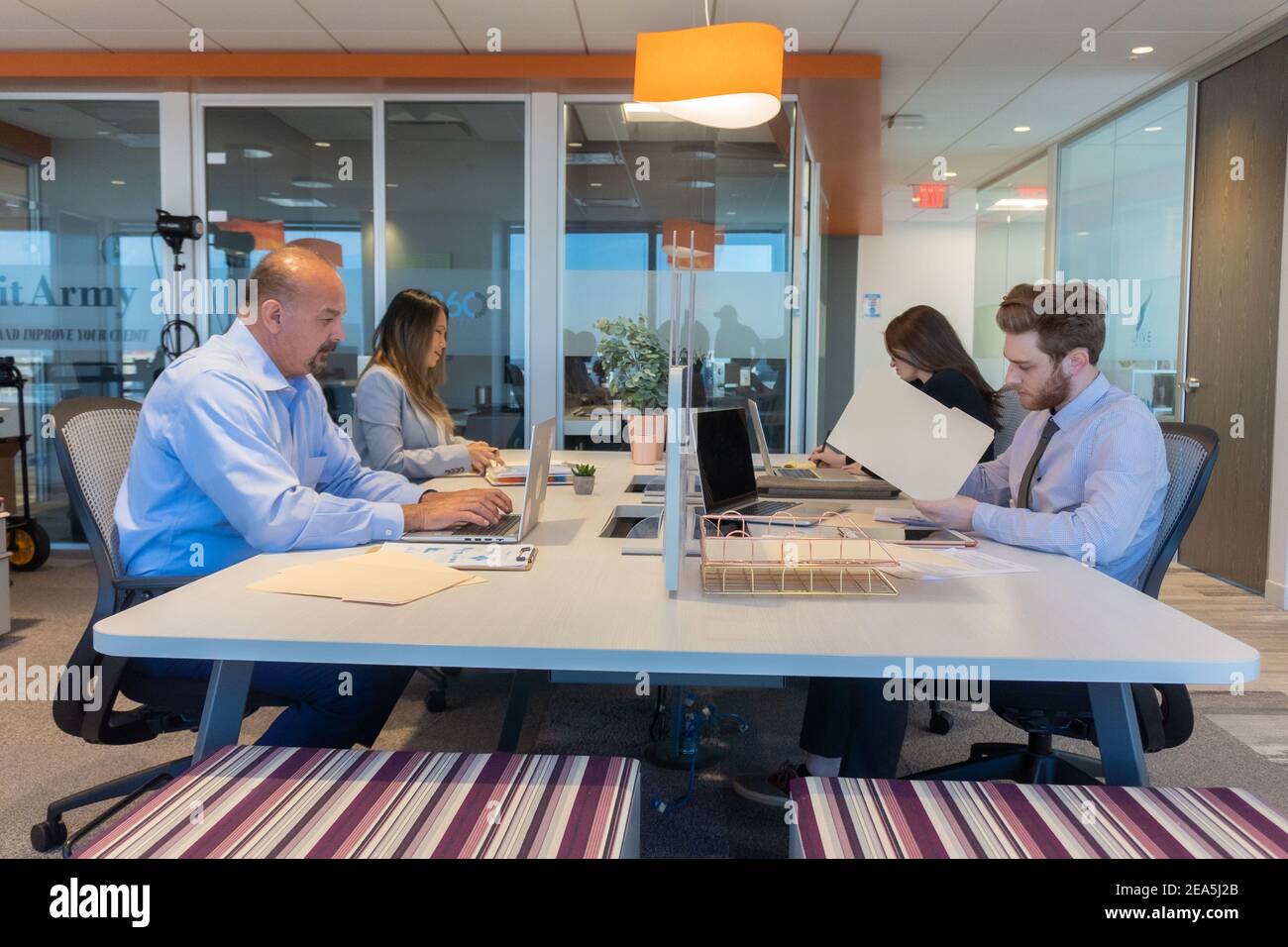 Office employee having a meeting with their team Stock Photo - Alamy