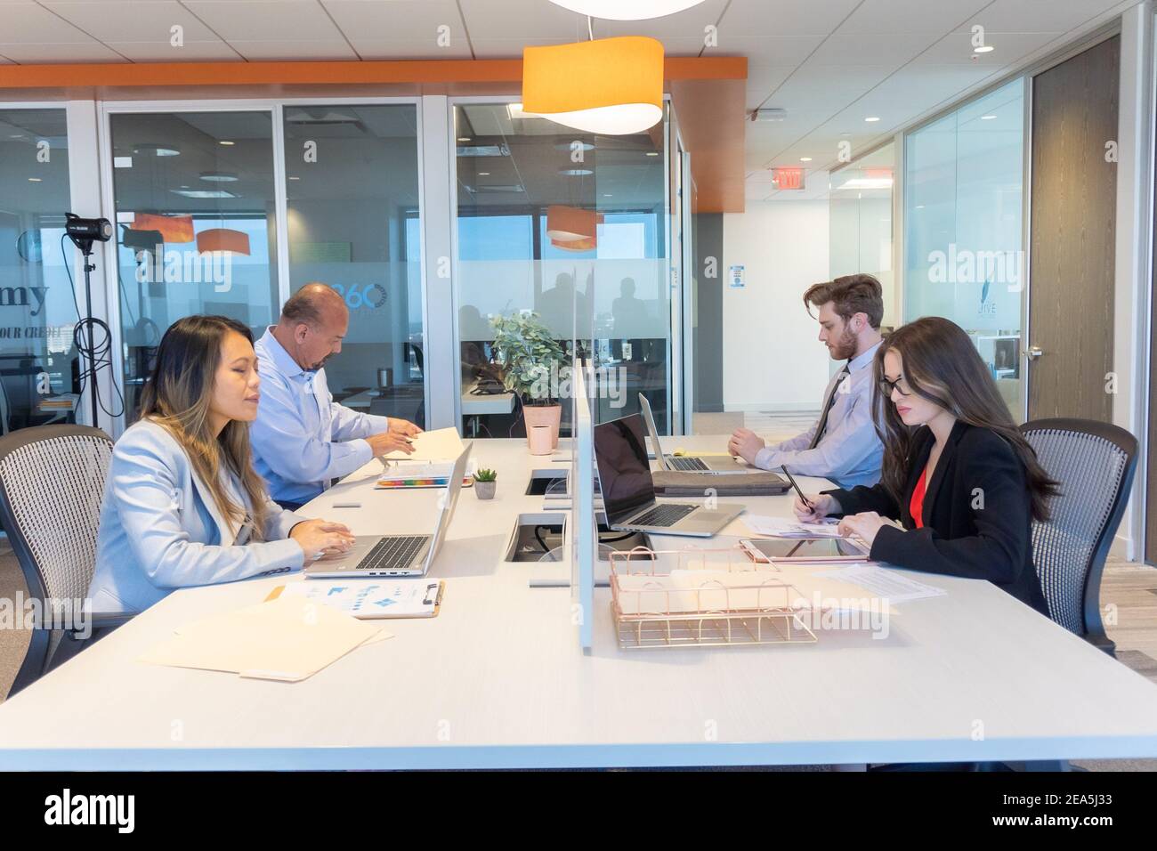 Office employee having a meeting with their team Stock Photo - Alamy